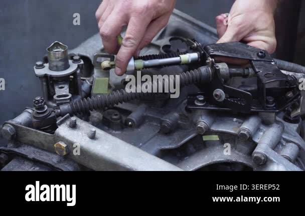 old gear shift box from a front-wheel drive car installing cables and ...
