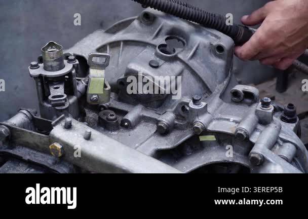 old gear shift box from a front-wheel drive car installing cables and ...
