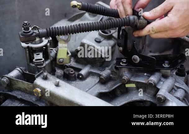 old gear shift box from a front-wheel drive car installing cables and ...