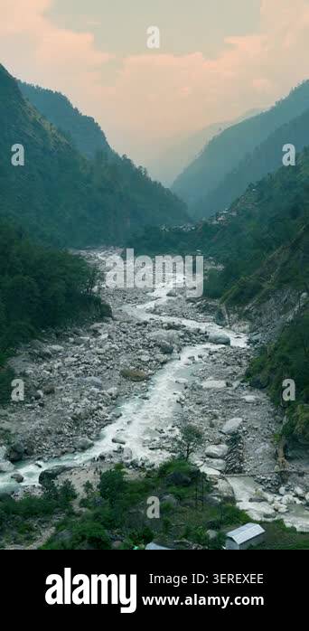Serene mountain landscape featuring a winding river through lush green ...