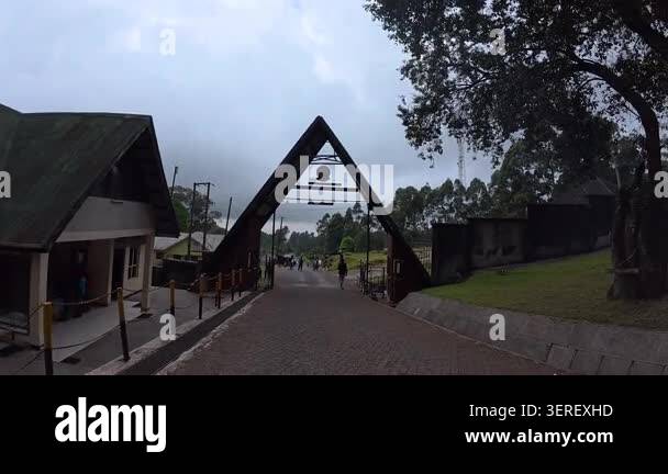 Vertical 4K footage showing a traveler approaching Machame Gate, a well ...