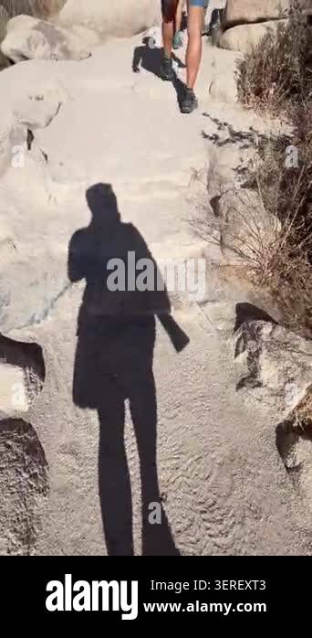 Vertical 4K footage of a self shadow hiking through the rocky Hidden ...