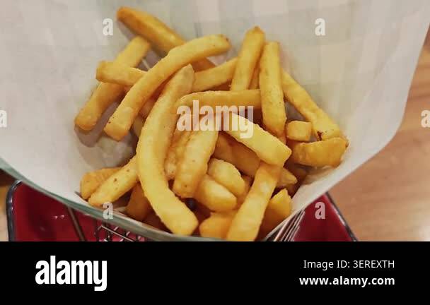 Crispy french fries in a paper cone Stock Video Footage - Alamy