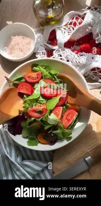Close up of a healthy fresh vegetarian salad with tomatoes and greens ...