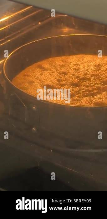 Delicious homemade cake rising and baking to golden perfection inside a ...