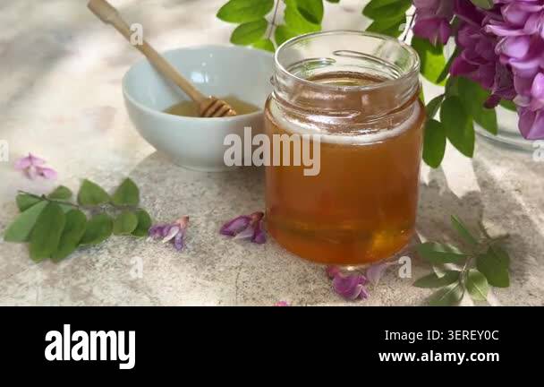 Fresh acacia flower honey jar still life Stock Video Footage - Alamy