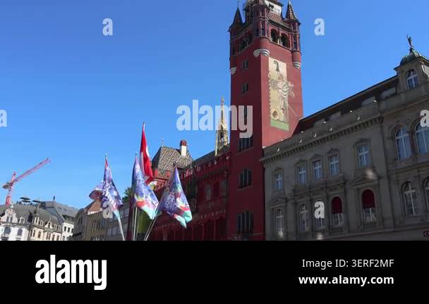 Basel, Switzerland, May 24, 2026: Colorful flags flutter in front of a ...