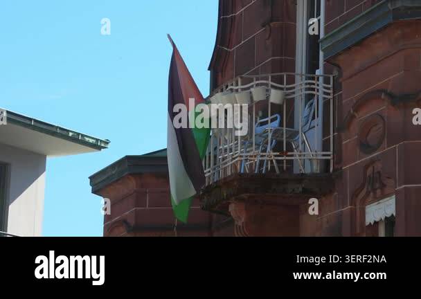 Basel, Switzerland, May 24, 2026: Colorful flag changes on a balcony ...