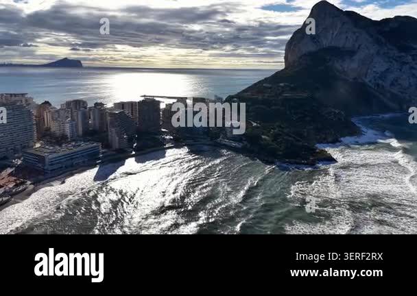 Aerial Rocky Promontory With Pounding Surf, Town Tucked Below Steep ...