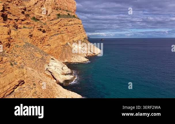 Red Sandstone Cliff Overlooking Turquoise Ocean, Remote Coastline ...