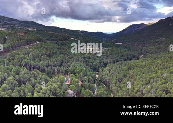 Aerial Verdant Valley Framed By Clouds, Forest Ranger Patrol Along ...