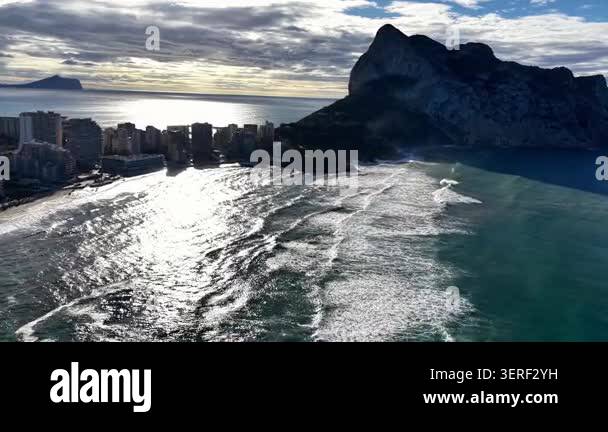 Surf And Rocky Headland With Foamy Waves And Reflective Sea, Drone Arc ...