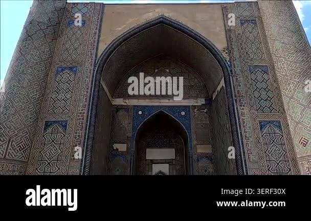 A 4K commercial low-angle tilt-up shot of the grand entrance portal of ...