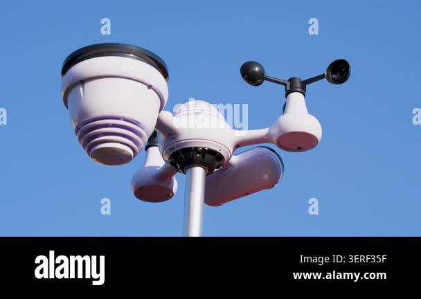 Weather station with wind cups and sensors installed on pole under ...