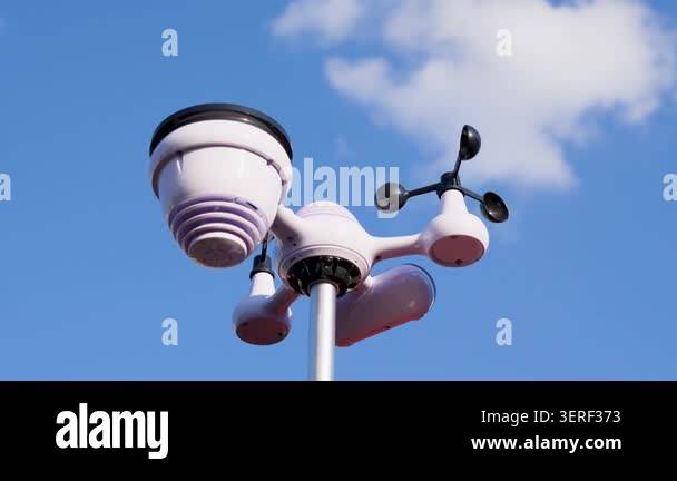 Weather station with wind cups and sensors installed on pole under ...