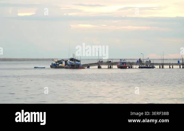 Scenic coastal harbor in cloudy evening light , Local fishing community ...