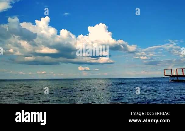 View of blue sea and blue sky with white clouds on sunny summer day ...