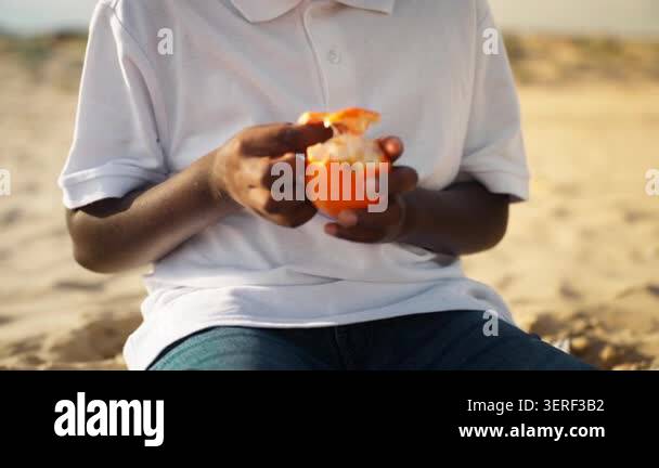 close up of african american kid with a orange fruit Stock Video ...