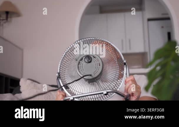 woman is holding an electric fan Stock Video Footage - Alamy