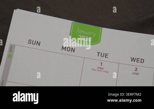 finger pointing at January 2030 planner page close up for future ...