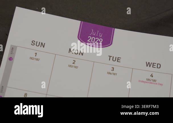 finger pointing at July 2029 planner page close up for scheduling and ...
