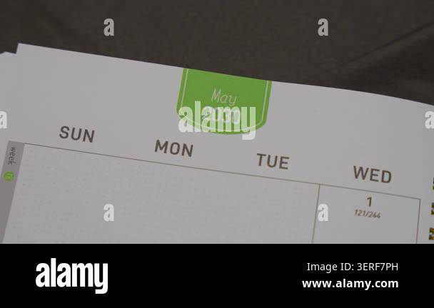 finger pointing at May 2030 planner page close up for future scheduling ...