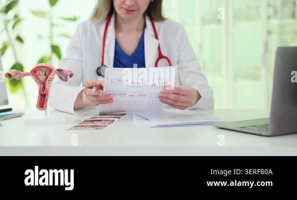 Female gynecologist plans shifts schedule holding calendar at desk with ...