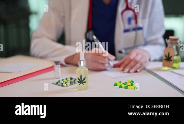 Female doctor prescribes medications with cannabis as sits at desk ...