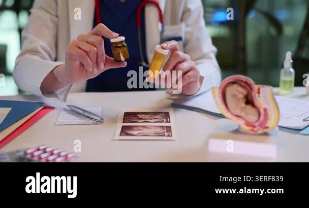Gynecologist gives vitamin supplements for pregnancy support in clinic ...
