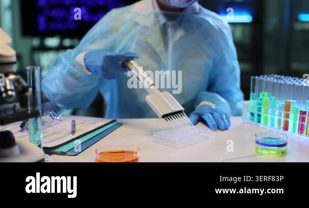 Chemist pours experimental liquid into transparent test tubes. Lab ...