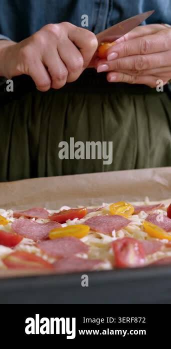 Woman Places Cherry Tomatoes Over Raw Pizza During Preparation In ...