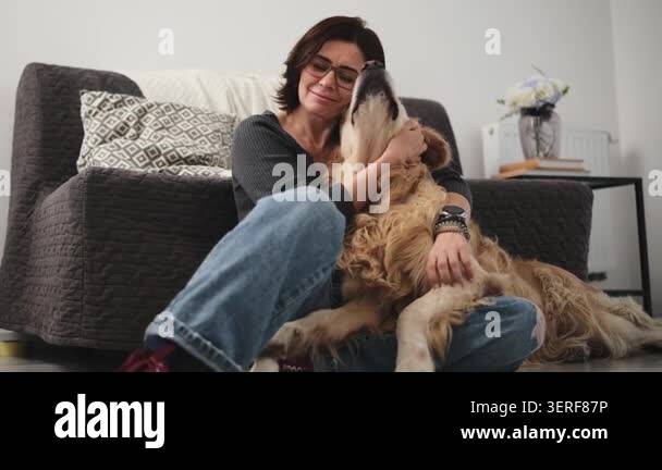 Woman Petting Golden Retriever On The Floor Of The House Stock Video ...