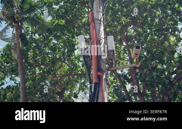 Nha Trang Vietnam. A utility pole with bundled cables and camera ...