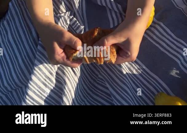 Top down video footage of female hands splitting a golden pastry in ...