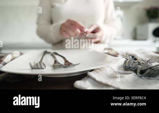 Girl Placing Washed Forks And Cutlery On A Plate Preparing For A Family ...