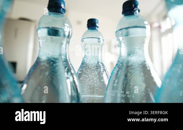 Smooth Camera Drives Among Big Blue Bottles Of Mineral Sparkling Water ...