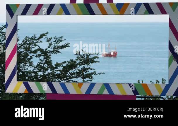 Creative view through a colorful striped frame capturing an old wooden ...