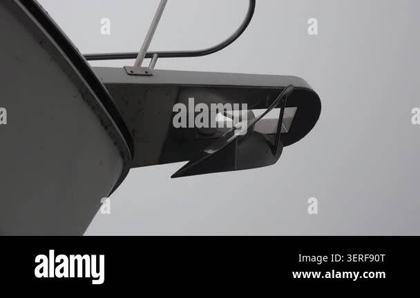 Low-angle view of a polished stainless steel anchor on the bow roller ...