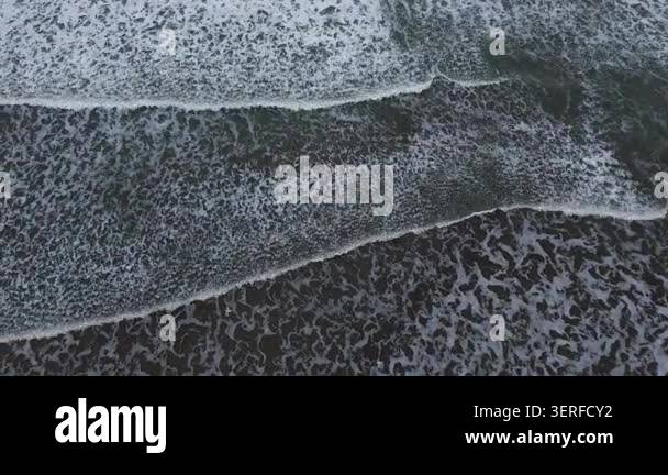 Aerial view of ocean waves crashing on the shore, showing the texture ...