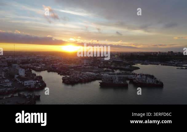 Aerial drone footage captures a wide view of a bustling harbor at ...