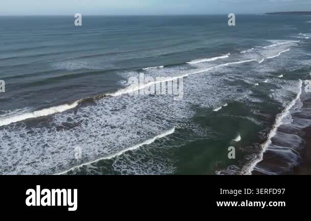 Aerial drone footage captures the vast ocean with rolling waves ...