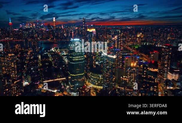 Colorful city lights of New York at night. Drone footage descends at ...