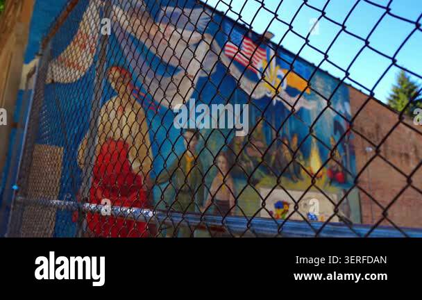 Low angle view of painted wall mural through metal fence, Chicago ...