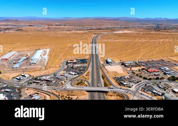 Wide-lane interstate highway crossing the little town. Drone footage ...