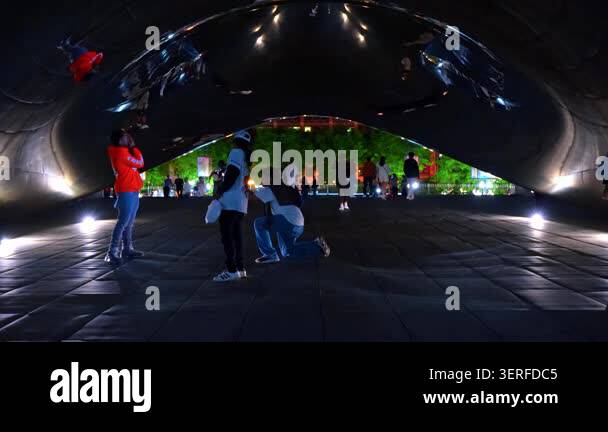 Chicago, USA, 7 May 2026: Visitors posing beneath mirrored canopy of ...