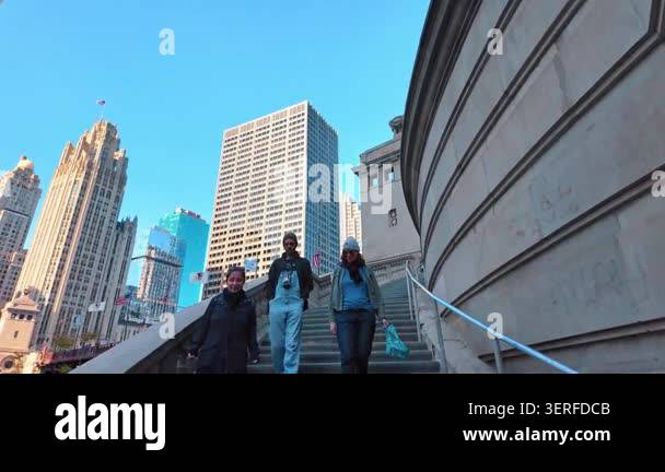Chicago, USA, 7 May 2026: Pedestrians descending stone staircase to ...