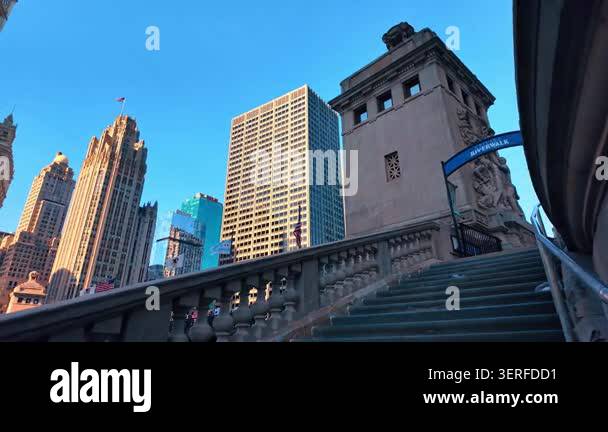 Gothic towers and riverwalk sign from stone staircase, downtown Chicago ...