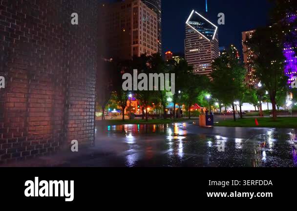 City park plaza and skyline after rain at night, Chicago, Illinois ...