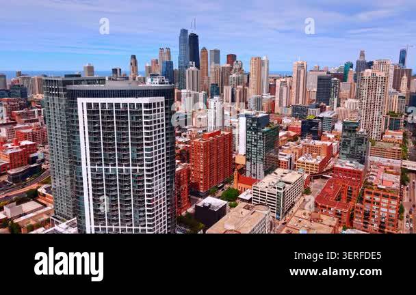 Footage over the modern cityscape with diverse colorful buildings ...
