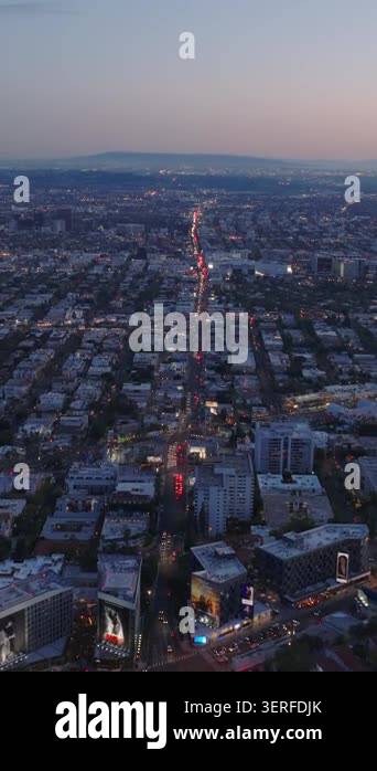 Aerial panoramic footage of metropolis at dusk. Buildings in urban ...